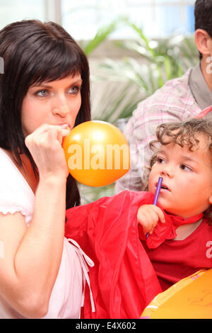 Child inflating balloon Stock Photo - Alamy