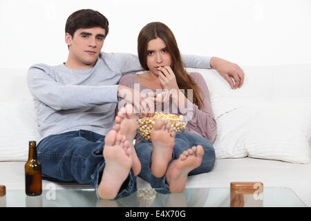 Spectators eating popcorn and watching a movie at cinema Stock Photo ...