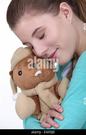 Portrait of a beautiful woman hugging her Teddy bear Stock Photo - Alamy