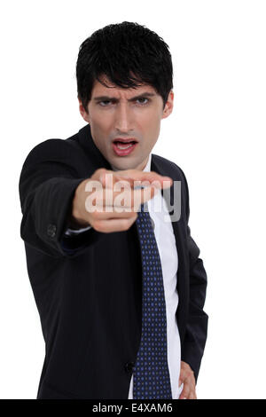 Angry businessman pointing and shouting Stock Photo - Alamy