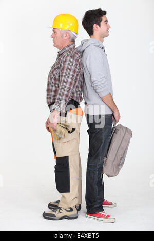 craftsman and apprentice standing back to back Stock Photo - Alamy