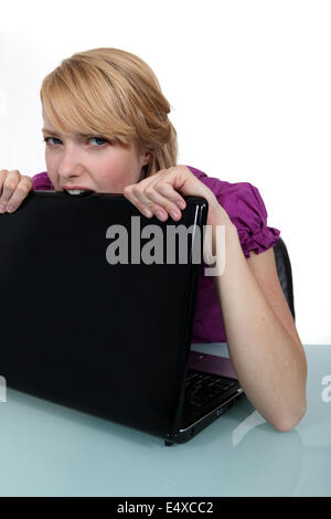 stressed business woman biting computer keyboard Stock Photo - Alamy