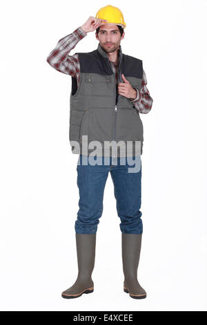 Construction worker giving a salute Stock Photo - Alamy