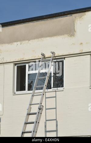 A ladder leaning against the exterior wall of a 1930s semi-detached ...