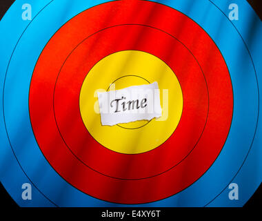 Time concept: target and Time is Now on wall background Stock Photo - Alamy