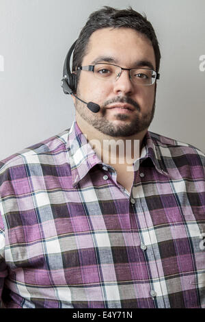 Smiling Customer service representative with headset on against a white ...