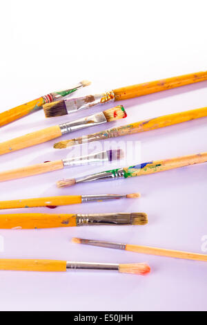Used paint brushes of different colors Stock Photo - Alamy