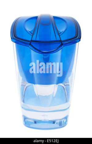 Modern filter jug and glass of water on kitchen counter near green wall ...