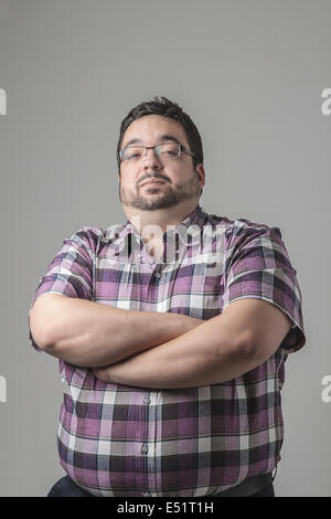 Portrait of overweight man with arms crossed Stock Photo - Alamy