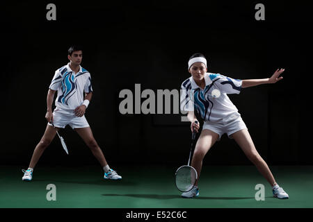 Man hitting shuttlecock with badminton racket Stock Photo - Alamy