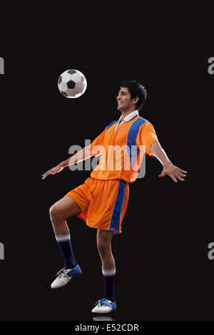 soccer player doing kick with ball on football stadium field isolated ...
