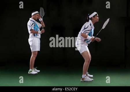 Profile shot of young female players talking to each other against ...