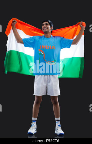 Full length photo of young man in striped t-shirt gesturing index ...