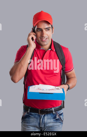 indian delivery man with bag and phone Stock Photo - Alamy