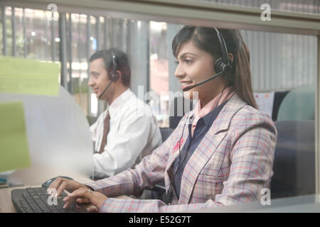 Male customer service executive working on computer at desk Stock Photo ...