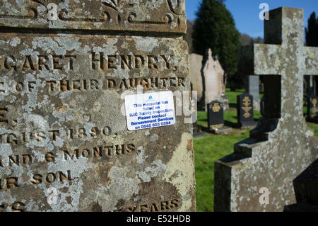 Memorial safety inspection notice on gravestones in a graveyard Stock ...