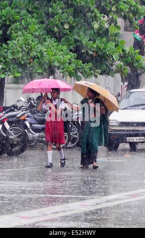 Allahabad, India. 18th July, 2014. School children cross a road during ...