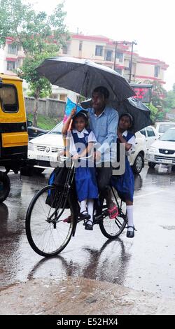 Allahabad, India. 18th July, 2014. Girls sharing umbrella during rain ...