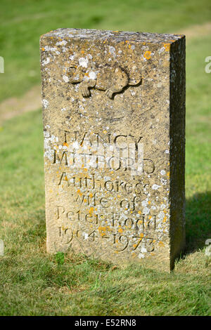 The grave of Nancy Mitford in the churchyard of St Marys church in the Cotswold village of ...