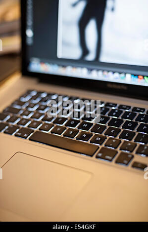 Apple Mac Book Pro keyboard, laptop, finger pointing at the Euro Stock ...