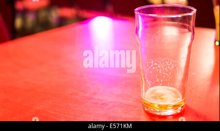 Almost empty glass of alcoholic drink Stock Photo - Alamy