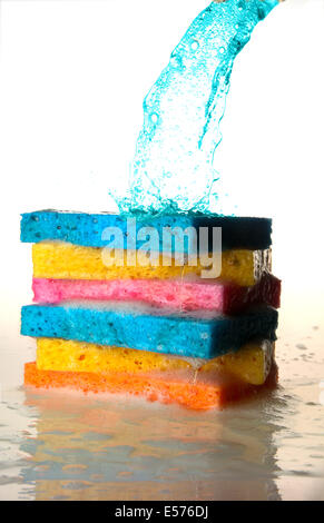 Mulit Colored Sponges Stacked on top of one another with Splash Stock ...