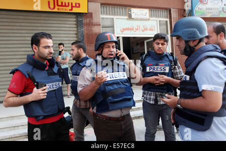 Al Jazeera Television newsroom with reporters and editors researching ...