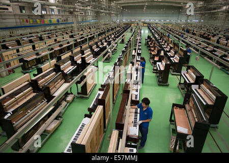 The main factory floor of the Beijing Xinghai Piano Group Ltd, in the ...