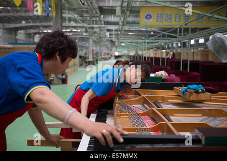 The main factory floor of the Beijing Xinghai Piano Group Ltd, in the ...