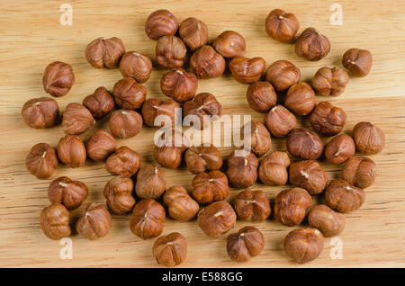 toasted hazelnuts without shells, on wood, background Stock Photo - Alamy