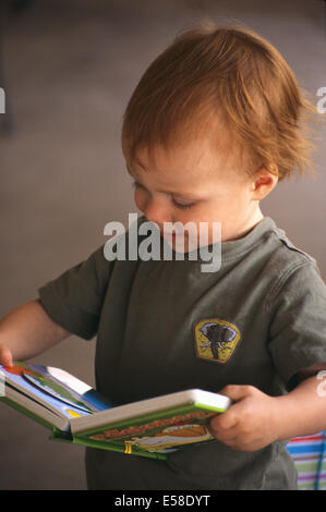 Child with red hair reading Stock Photo - Alamy