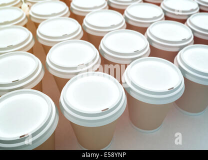 A row of paper coffee cups on a white background Stock Photo - Alamy
