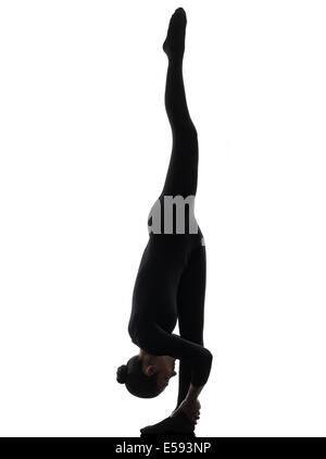 one woman contortionist practicing gymnastic yoga in silhouette on ...