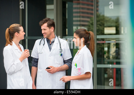 Doctors talking to each other and smiling Stock Photo - Alamy