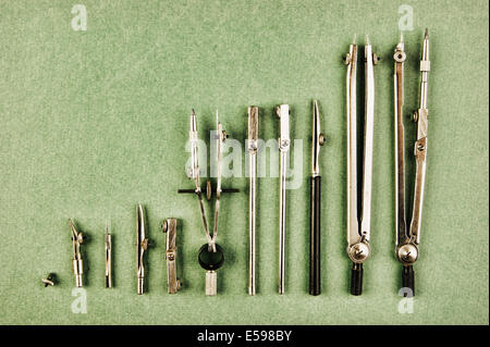 Old drawing tools on a green background Stock Photo - Alamy