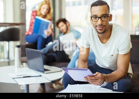 Male entrepreneur using digital tablet while standing at office Stock ...