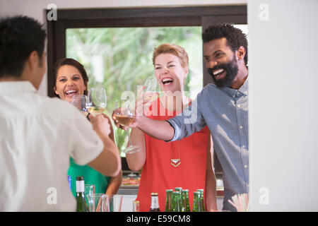 Young african american woman toasting with wine sitting by christmas ...