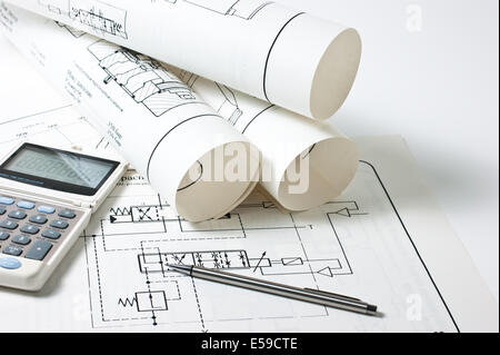 rolled technical drawings and a calculator Stock Photo - Alamy