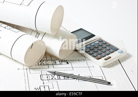 rolled technical drawings and a calculator Stock Photo - Alamy