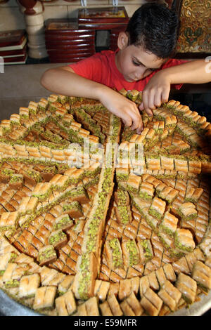 Damascus, Syria. 24th July, 2014. A Syrian man makes Arabic sweets in ...
