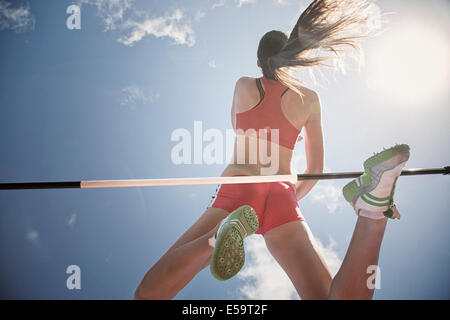 Female high jumper clearing bar Stock Photo - Alamy