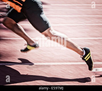 Sprinter taking off from starting block on track Stock Photo - Alamy