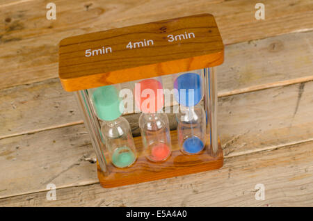 Multiple hourglass with colorful sand running Stock Photo - Alamy