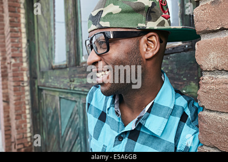Hispanic young man smiling at the street Stock Photo - Alamy