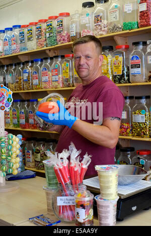 shopkeeper serving sweets at a traditional english sweet shop Stock ...