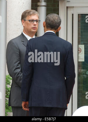 U.S. Deputy Chief of Mission Peter Haymond waters a tree planted during ...