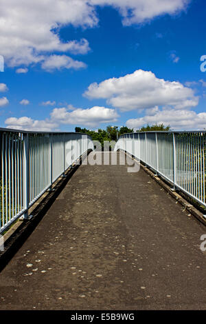 A footbridge over the M3 motorway in Surrey is shown in this black and ...