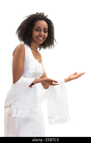 A young tribal woman making traditional Pongadam sweets in Araku ...
