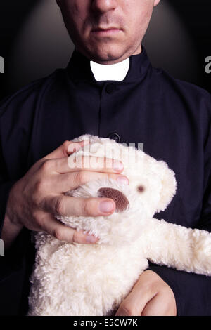 priest holding a teddy bear Stock Photo - Alamy