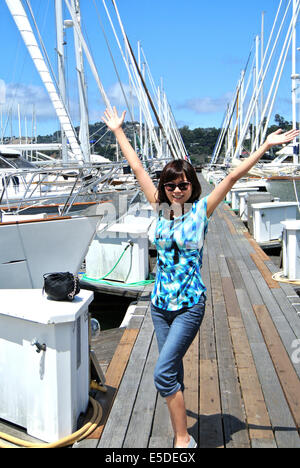 Pretty asian woman in t-shirt touching head isolated on blue Stock ...